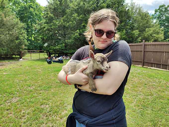 Holding a baby goat: the kind of therapy your insurance doesn't cover but absolutely should, trust me.