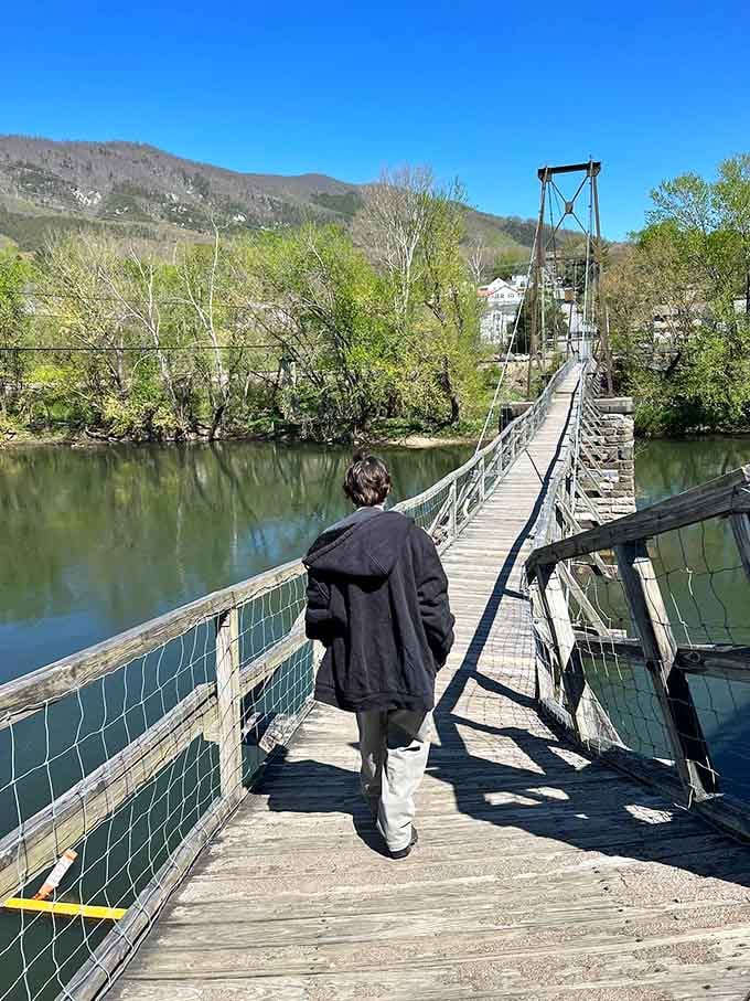 One brave soul ventures across, about to discover why they call it a "swinging" bridge firsthand.