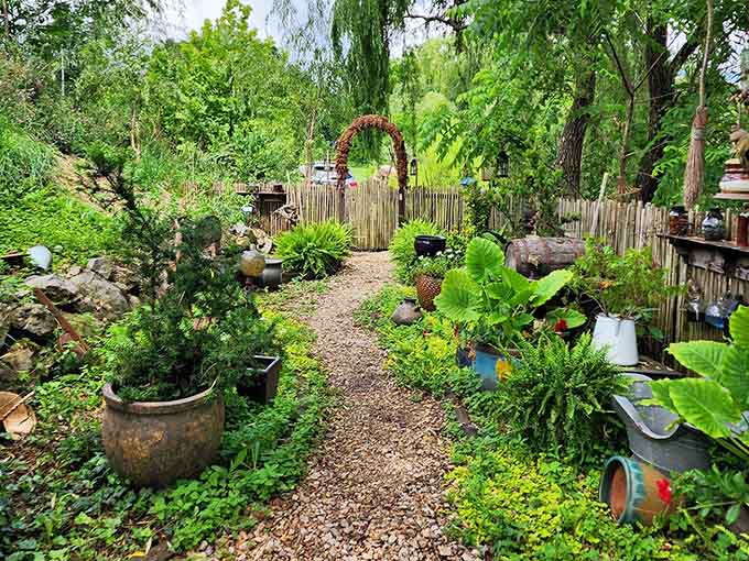 Lush garden paths wind through carefully curated greenery that feels both wild and intentionally magical.
