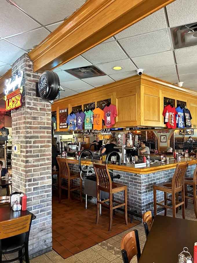 The bar serves as command central where cold drinks meet warm conversation in perfect harmony every single day.