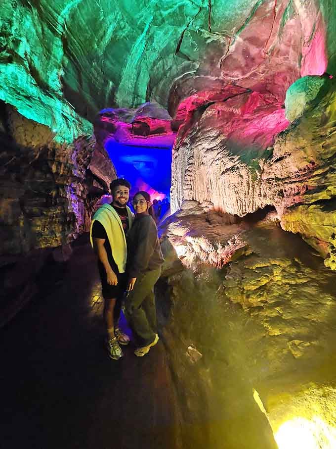 Visitors posing in front of illuminated formations, capturing memories that their phone cameras will never quite do justice.