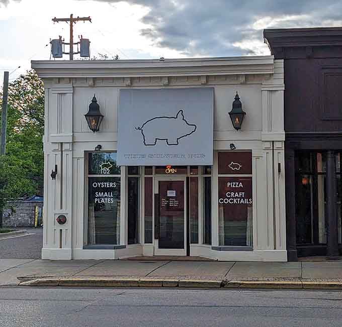 A minimalist pig outline on pristine white says this place takes its food seriously without taking itself too seriously.