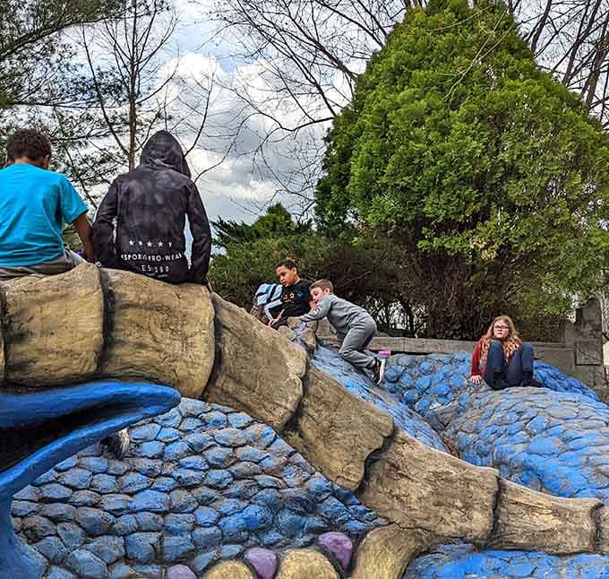 Children scramble over the dragon's scales like it's the world's coolest jungle gym, which it absolutely is, no contest.