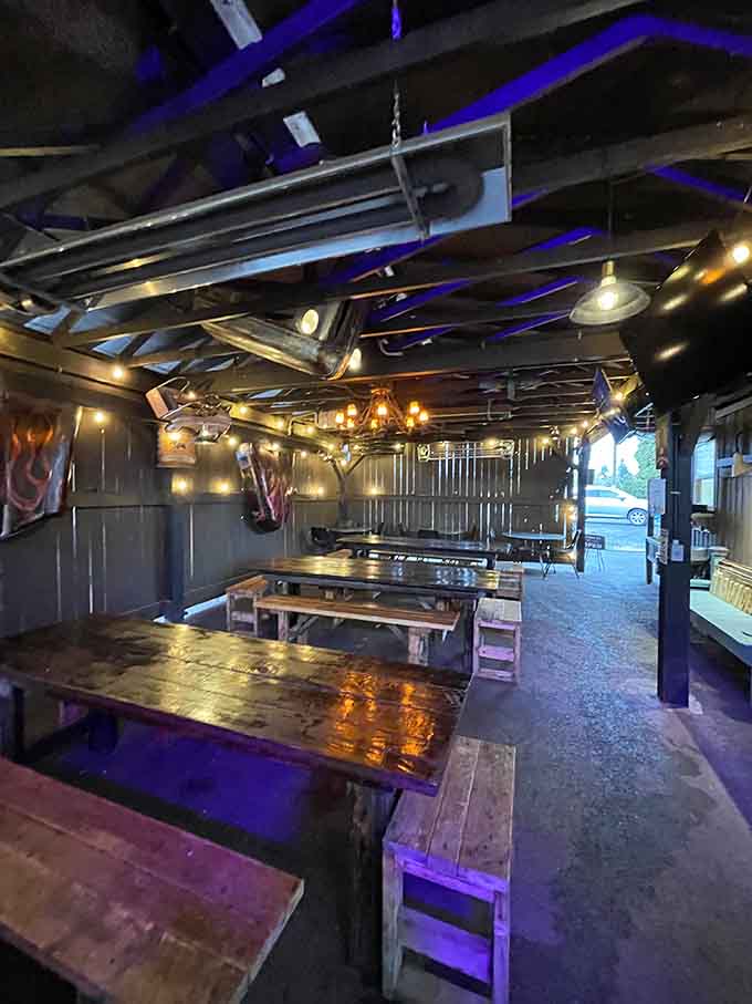 Blue mood lighting transforms picnic tables into something almost fancy, in the best junkyard way possible.