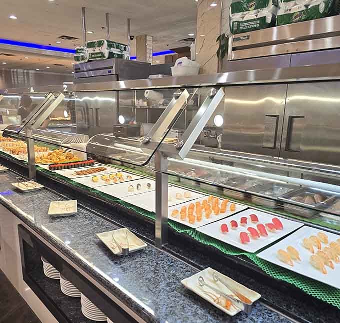 The sushi bar displaying fresh rolls like jewelry, because sometimes raw fish deserves the red carpet treatment it's getting.
