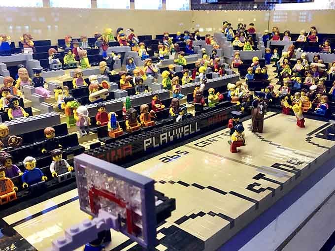 Miniature fans fill stadium seats in this remarkably detailed arena built entirely from interlocking plastic pieces.