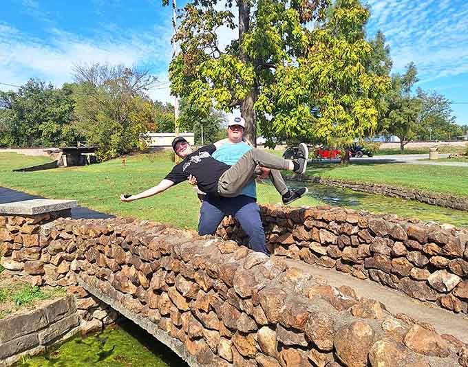 Visitors pose on the stonework like they've just discovered their own personal slice of paradise, because they have.