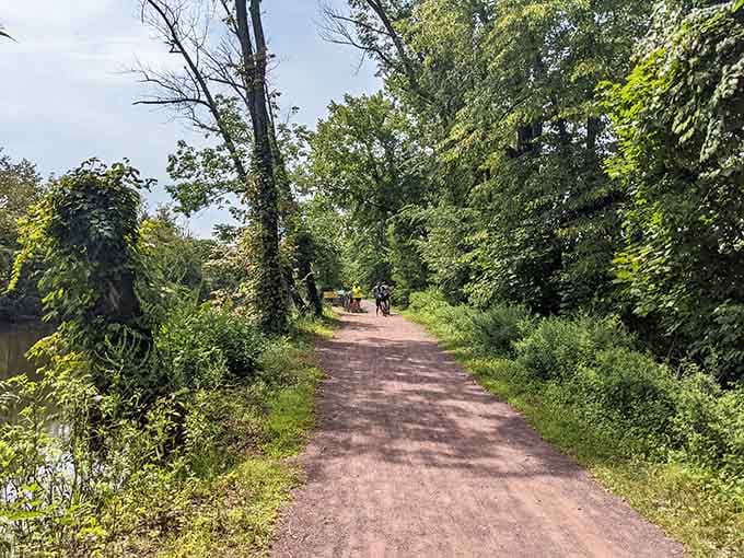 The tree-canopied towpath invites leisurely strolls where your biggest decision is whether to walk or bike slowly.