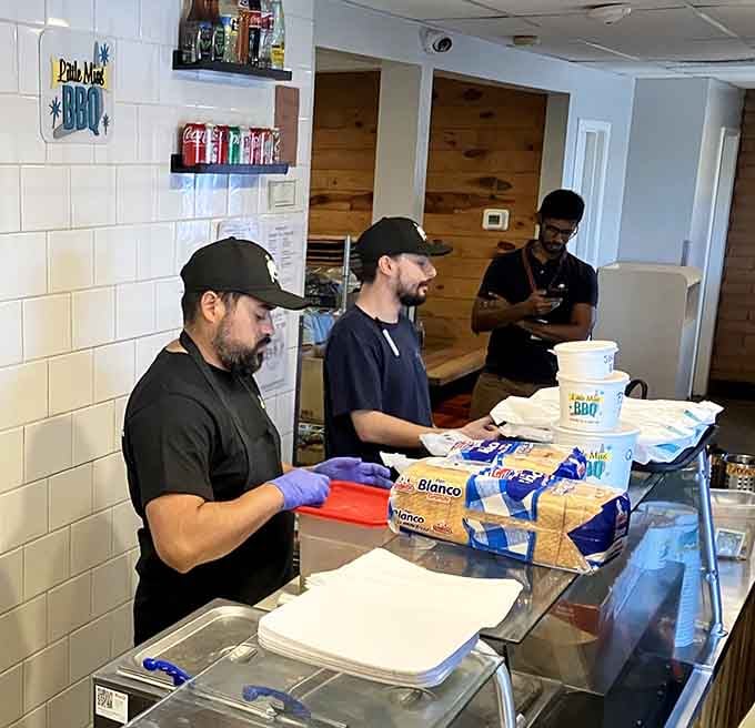 The skilled crew working efficiently to feed the masses, turning raw meat into smoky perfection all day.