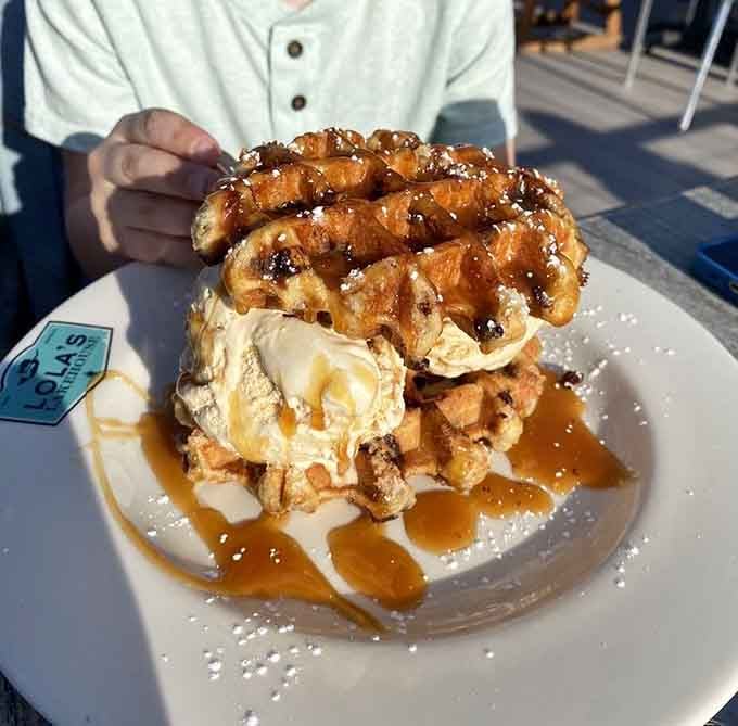 This waffle dessert tower defies gravity and common sense, and we're absolutely here for every glorious bite.