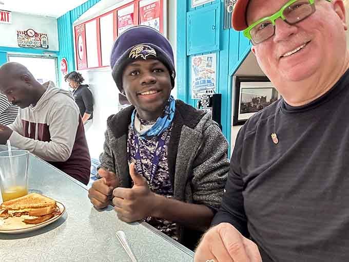 The smiles say it all: this is where strangers become friends over exceptional diner food.