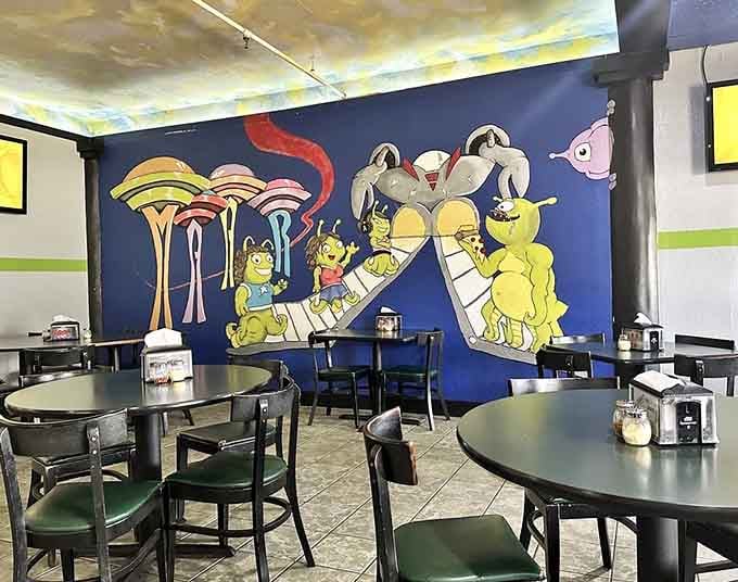 Whimsical space murals featuring aliens on adventures, making every meal feel like a journey beyond Earth's atmosphere.