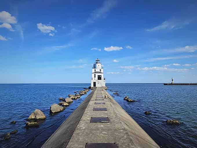 The lighthouse stretches toward Lake Michigan like hope reaching across water, accessible and utterly free.