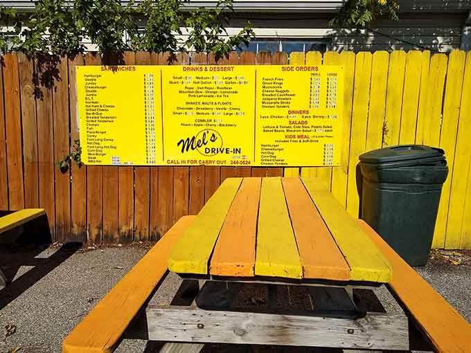 Outdoor seating painted in cheerful yellow, where you can enjoy your meal while pretending it's still 1957.