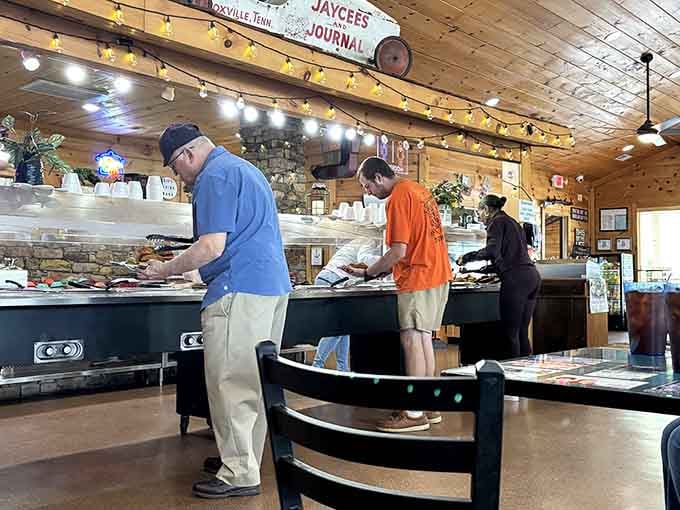Real people loading real plates with real Southern cooking, no pretense, just pure delicious satisfaction ahead.