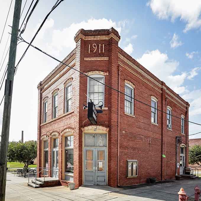 This historic brick building from 1911 stands as a testament to Milledgeville's enduring character and architectural preservation efforts over decades.