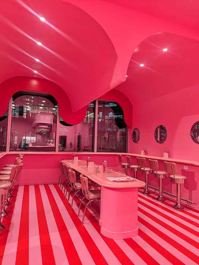 Striped floors and pink everything create a diner vibe that Willy Wonka would absolutely approve of.