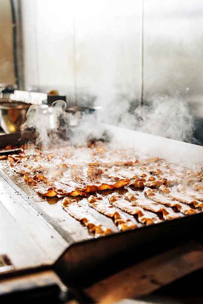 Bacon sizzling on the griddle, sending up smoke signals that breakfast is about to get seriously good.