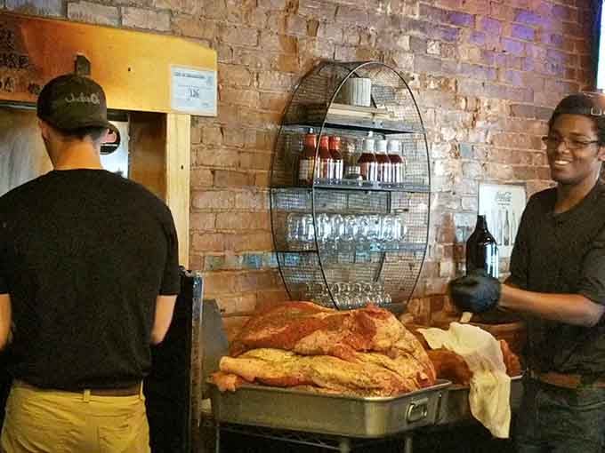 Staff preparing fresh smoked meats, because great barbecue requires dedication, skill, and probably some very early mornings.