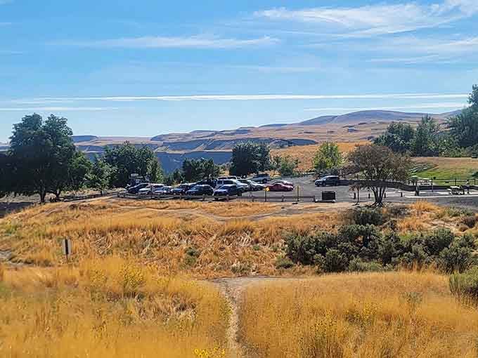 The parking area surrounded by open hills, your last taste of civilization before the canyon steals the show.