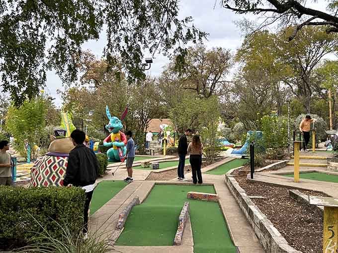Families navigate the colorful course together, proving that mini-golf is the great equalizer of athletic ability and competitive spirit.