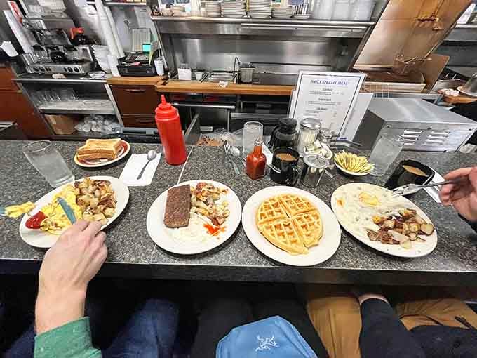 Four plates of happiness waiting for their forever homes, each one a masterclass in diner perfection.
