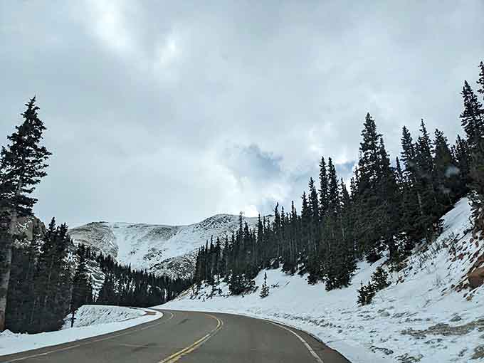 Snow blankets the peaks ahead, creating a winter wonderland that exists year-round at these extreme elevations.