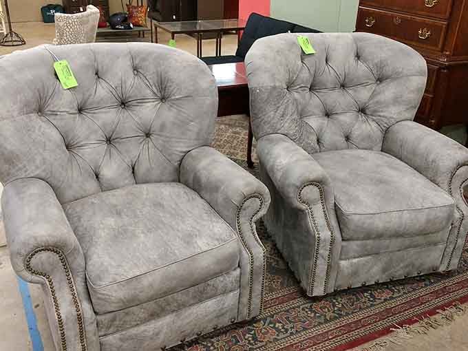 Those tufted chairs are begging you to sit down with a good book and pretend you're in a Victorian library.