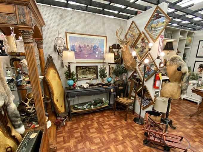 Rustic cabin vibes with antlers and artwork, perfect for anyone channeling their inner outdoorsman without actual camping required.