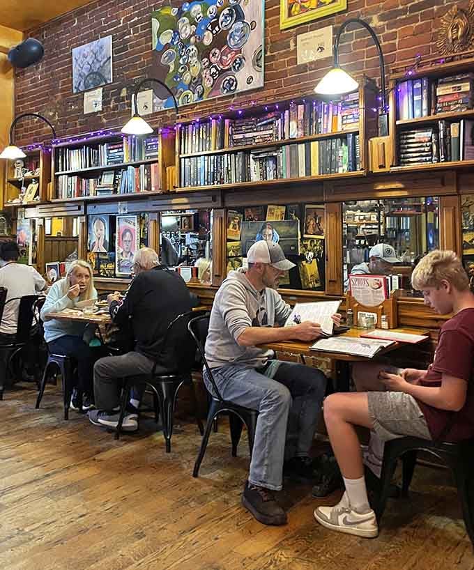 Families and friends gathered around tables with books nearby—this is what community spaces should look like in every town.