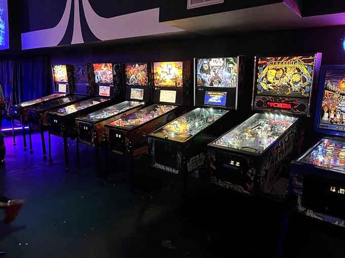 A pristine lineup of pinball machines waits patiently, their silver balls ready to bounce through mechanical wonderlands.
