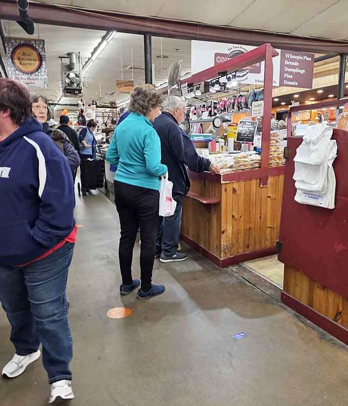 The indoor market buzzing with shoppers who know that Tuesday mornings are for serious treasure hunting, not sleeping in.