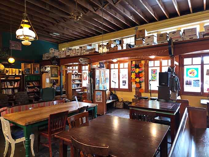 Mismatched furniture and warm lighting create the living room you wish you had, complete with full bar service.