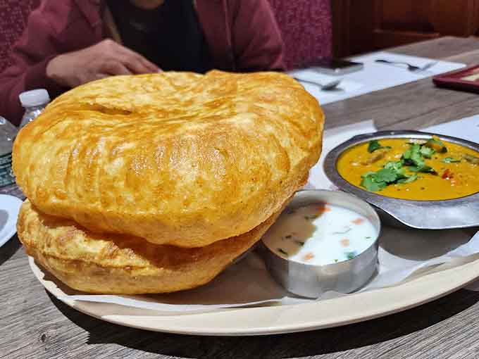 That chole bhature puffs up like it's defying gravity, golden and glorious and absolutely worth the carb commitment.