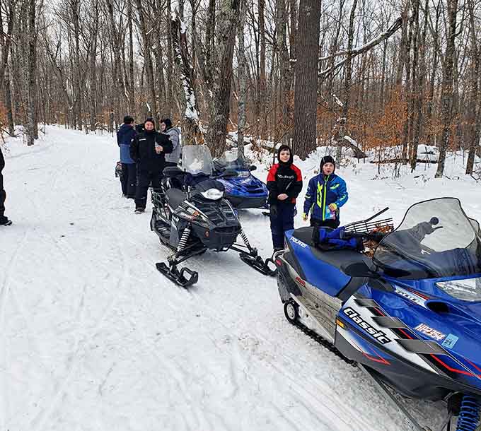 Winter snowmobiling transforms the trails into frozen highways for people who think skiing is too much work anyway.
