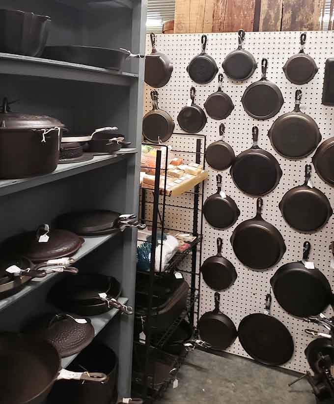 Cast iron cookware hangs like edible art, ready to outlive us all while making perfect cornbread for generations.