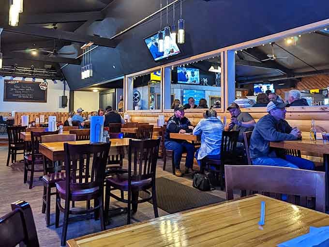 Happy diners gathered around tables, united in their appreciation for properly smoked meat and cold beer.
