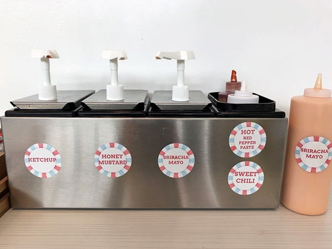The condiment station offers everything from honey mustard to sriracha, because customization is half the fun of eating here.
