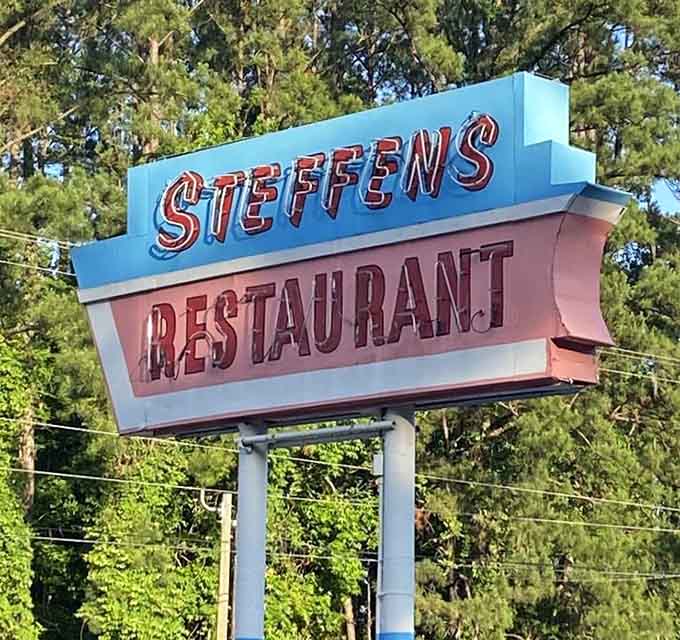 A vintage sign standing tall, guiding hungry travelers like a delicious beacon of hope since forever.