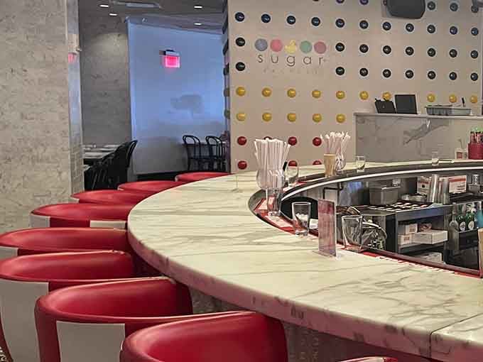 Counter seating with a marble top invites you to watch the candy magic happen while contemplating your life choices.