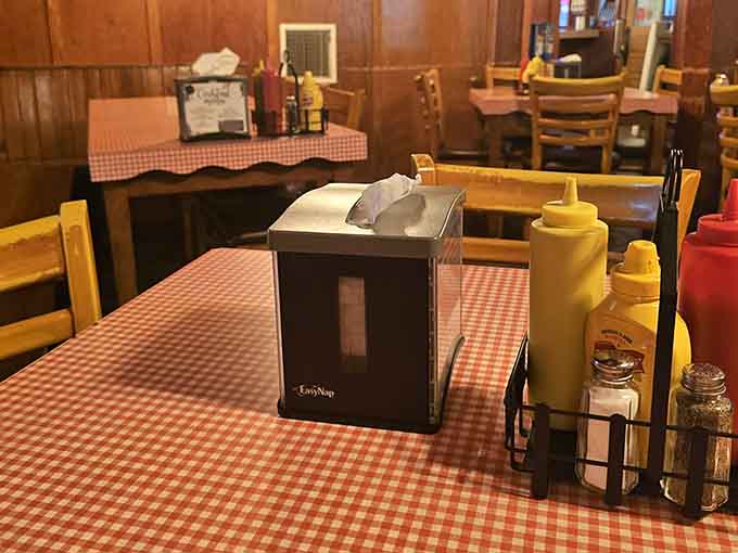 Mustard, ketchup, salt, and pepper standing at attention on a checkered tablecloth. The classics never need an introduction.