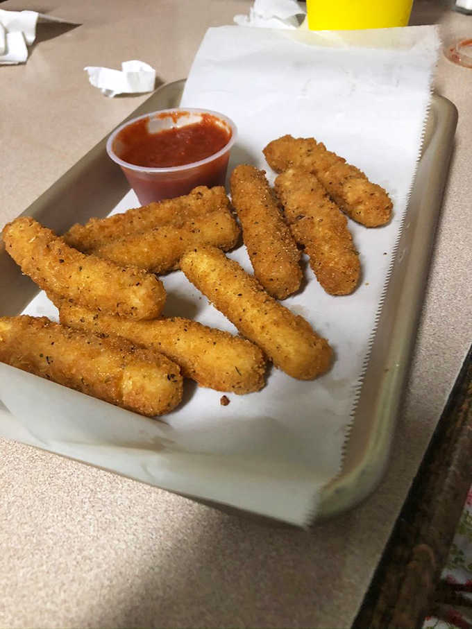 Mozzarella sticks lined up like golden soldiers, ready to wage delicious war on your willpower and diet.