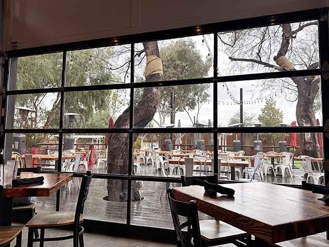Floor-to-ceiling windows frame the patio view, blurring the line between indoor comfort and outdoor Arizona beauty.