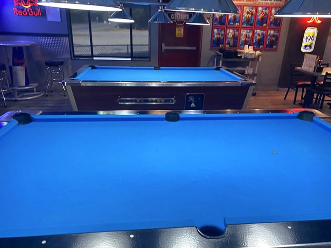 Two regulation pool tables ready for friendly competition or settling disputes about who's buying the next round of drinks.
