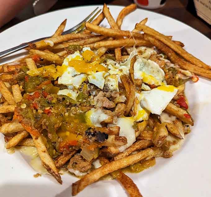 Poutine topped with green chile because even Canadian comfort food gets a Colorado makeover here.