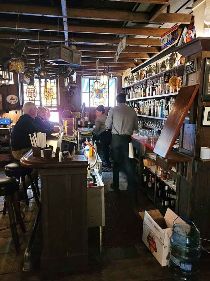 The Lion's Den bar offers cozy refuge where good drinks and better conversation happen naturally, without shouting required.