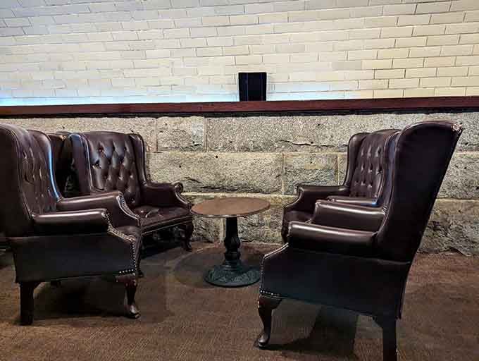 Wingback leather chairs facing each other across a tiny table, the perfect setup for solving mysteries or sharing secrets.
