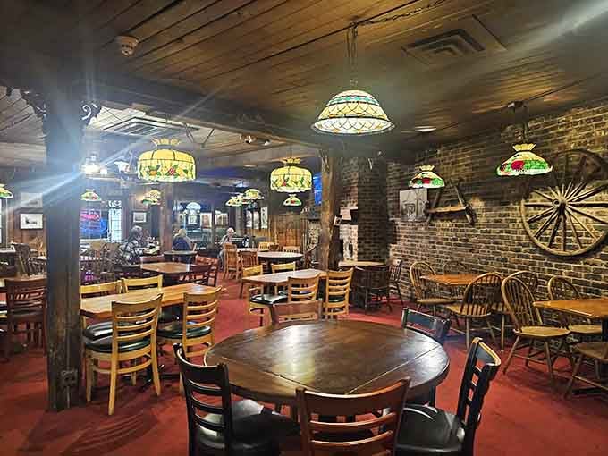 Tiffany-style lamps cast warm light over tables where strangers become friends and regulars feel like family every single visit.