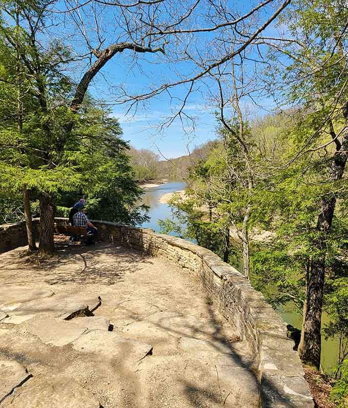 Stone overlooks provide panoramic views of the winding creek below, ideal for contemplation or sandwich consumption.