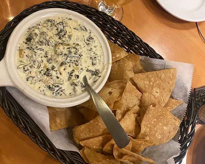 Spinach dip with tortilla chips serves as the warm-up act before the main event takes the stage.